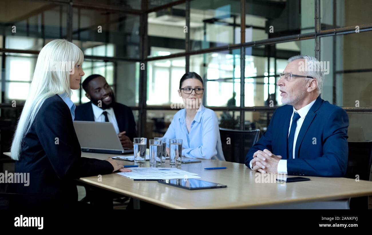 Company managers listening to senior colleagues report, business ...