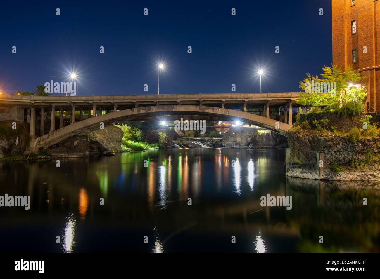 Late night along the Spokane River as lights reflect off the water in ...