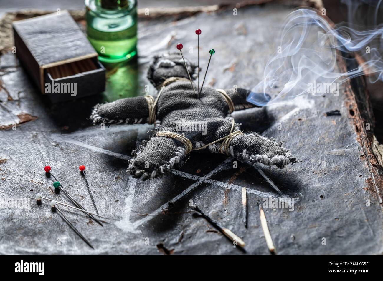 Scary voodoo doll burned with fire as harming Stock Photo - Alamy