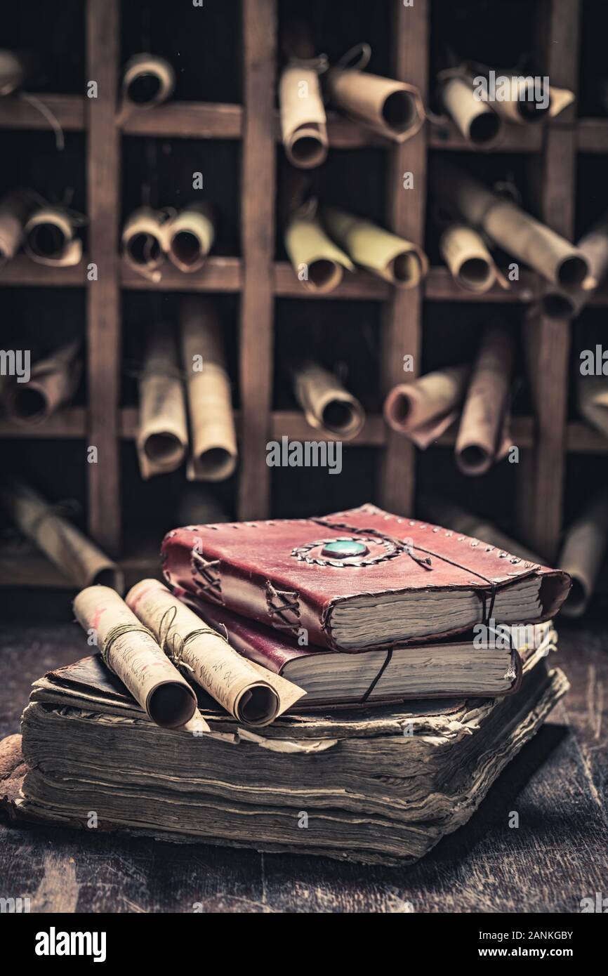 Magic books and scrolls in antique library Stock Photo - Alamy