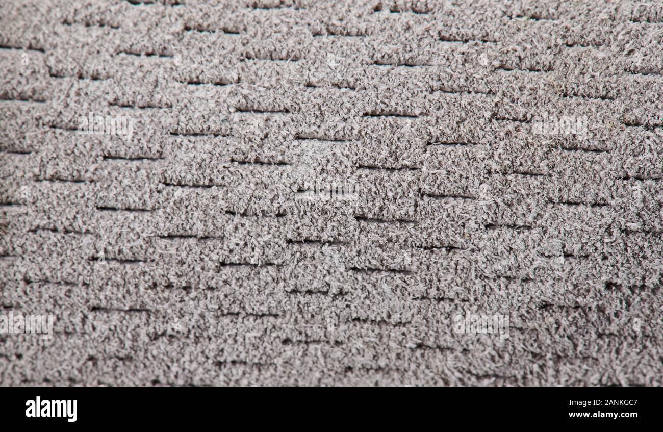 Perforated gray fluffy fabric background close up view Stock Photo - Alamy