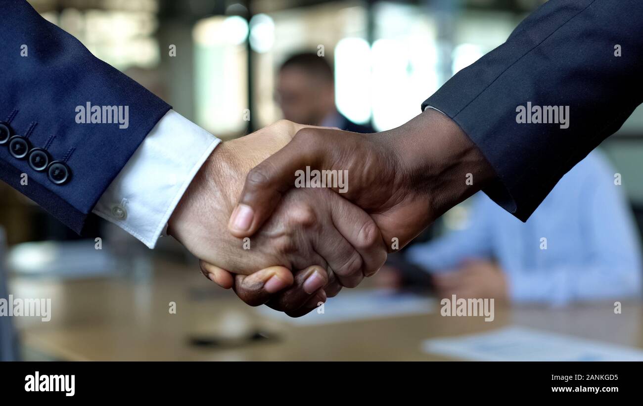Business handshake close-up, partners shaking hands for agreement ...