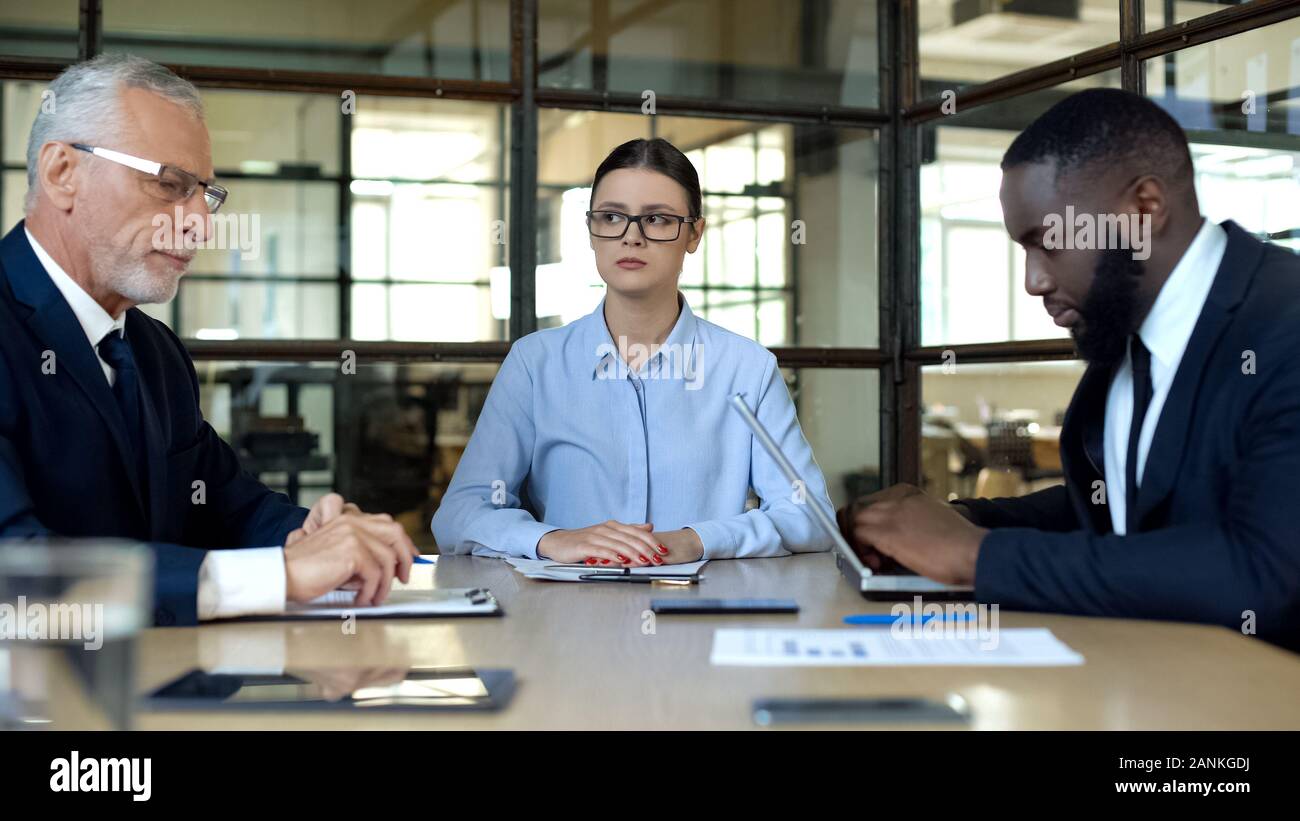 Strained atmosphere in office, silent colleagues in conflict, stress at ...