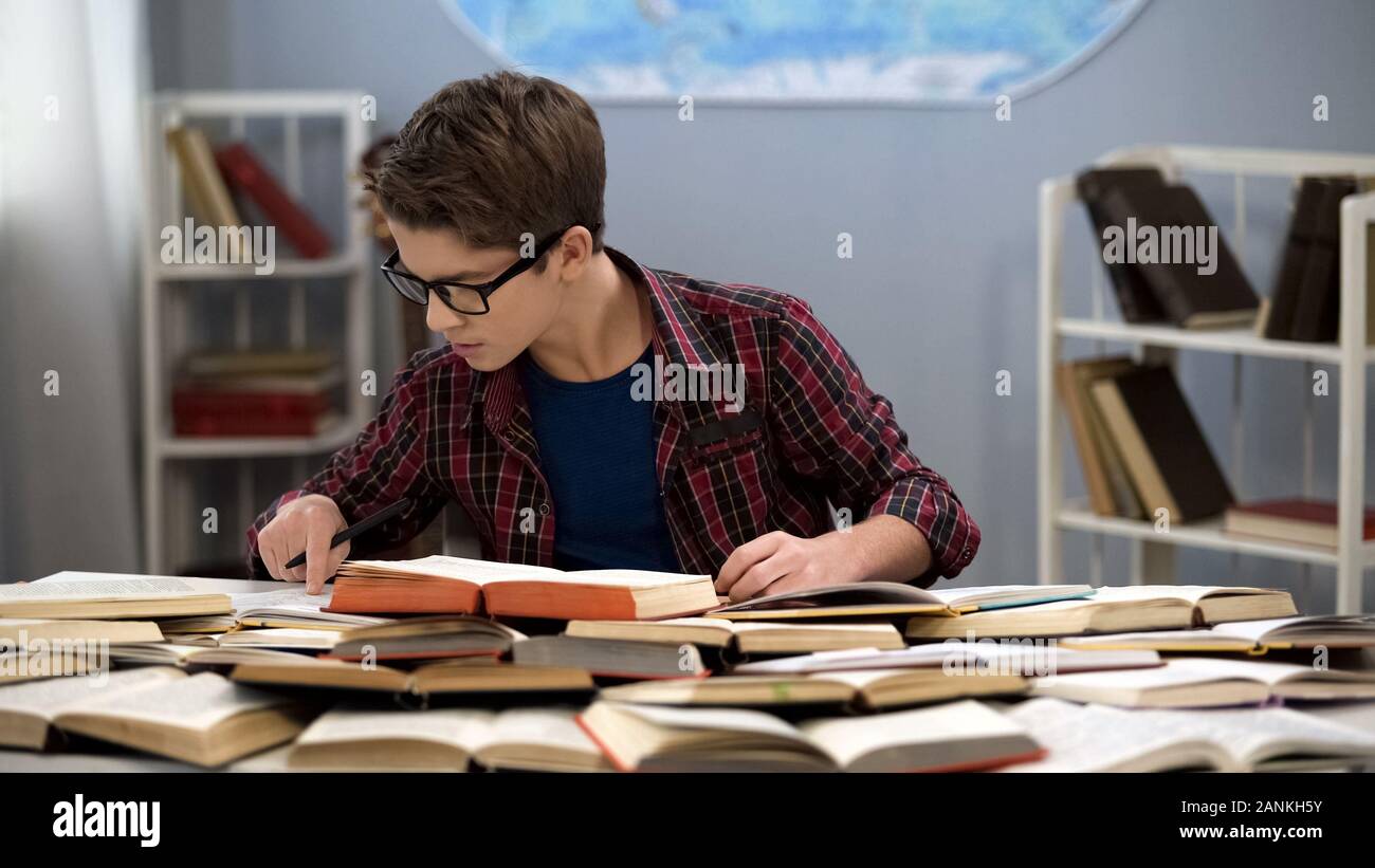 Genius school pupil reading books sitting table, study research ...
