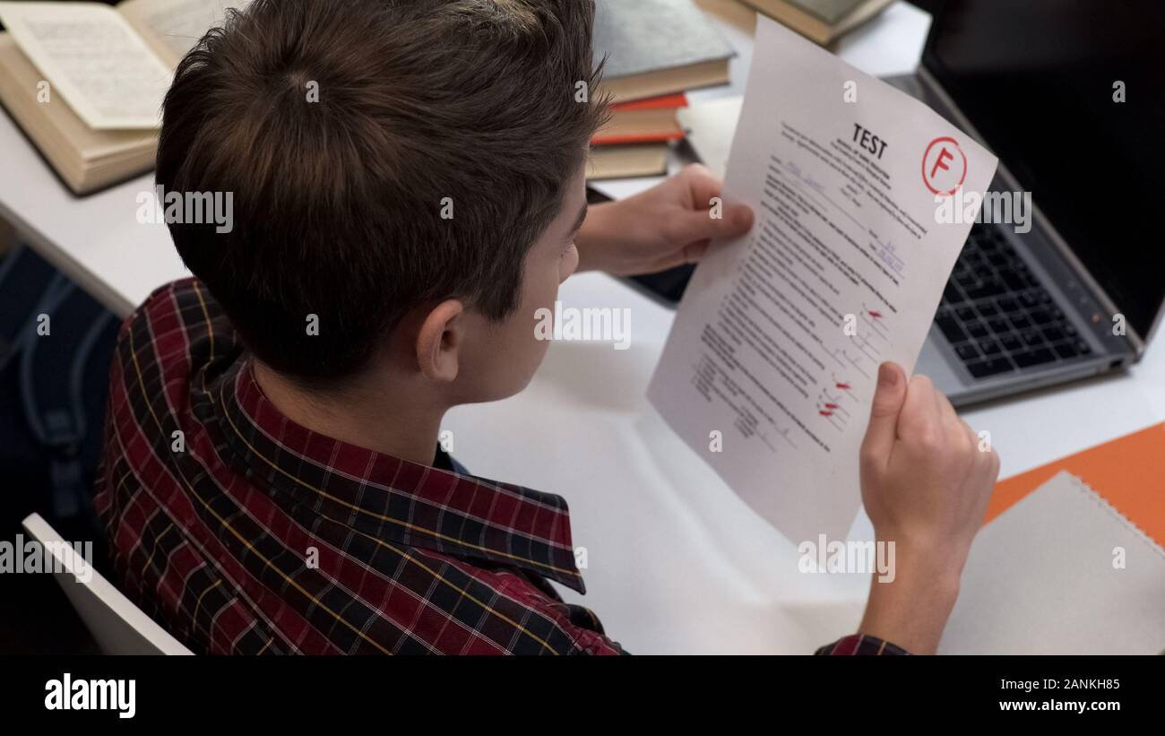 Child reading test result holding paper sheet with negative mark ...