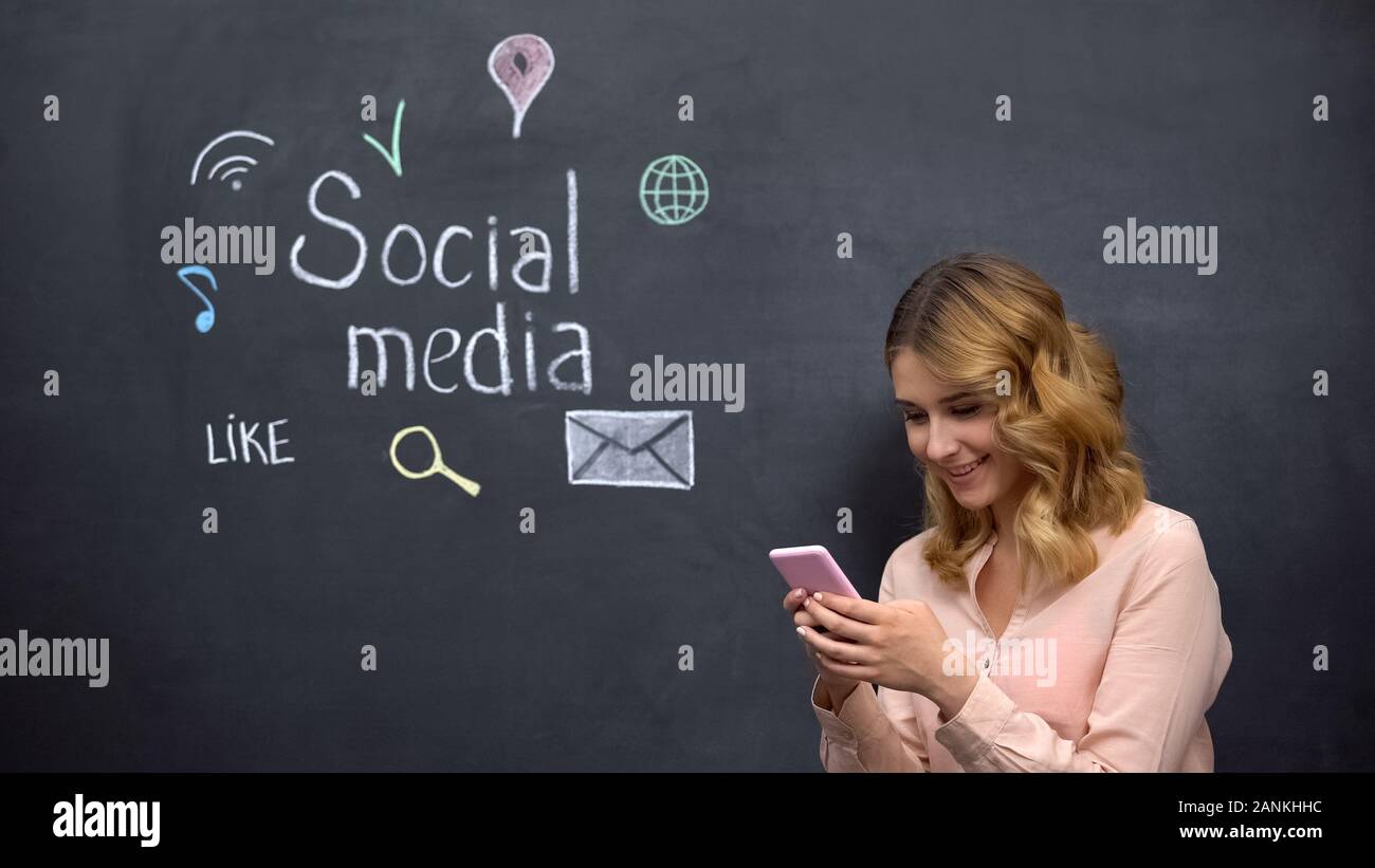 Girl posting message in social media using cell phone, global ...