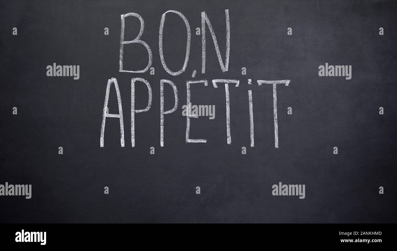 Bon Appetit phrase written on blackboard, high-end restaurant ...