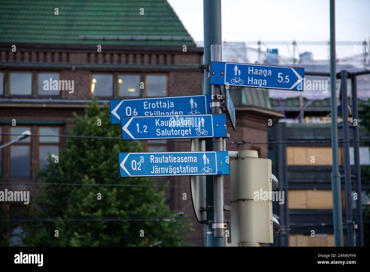 Many directional signs mounted on a pole in the crossing in Helsinki ...