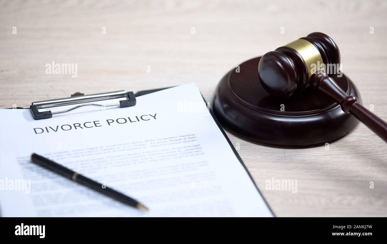 Divorce policy document on table, gavel lying on sound block, family ...