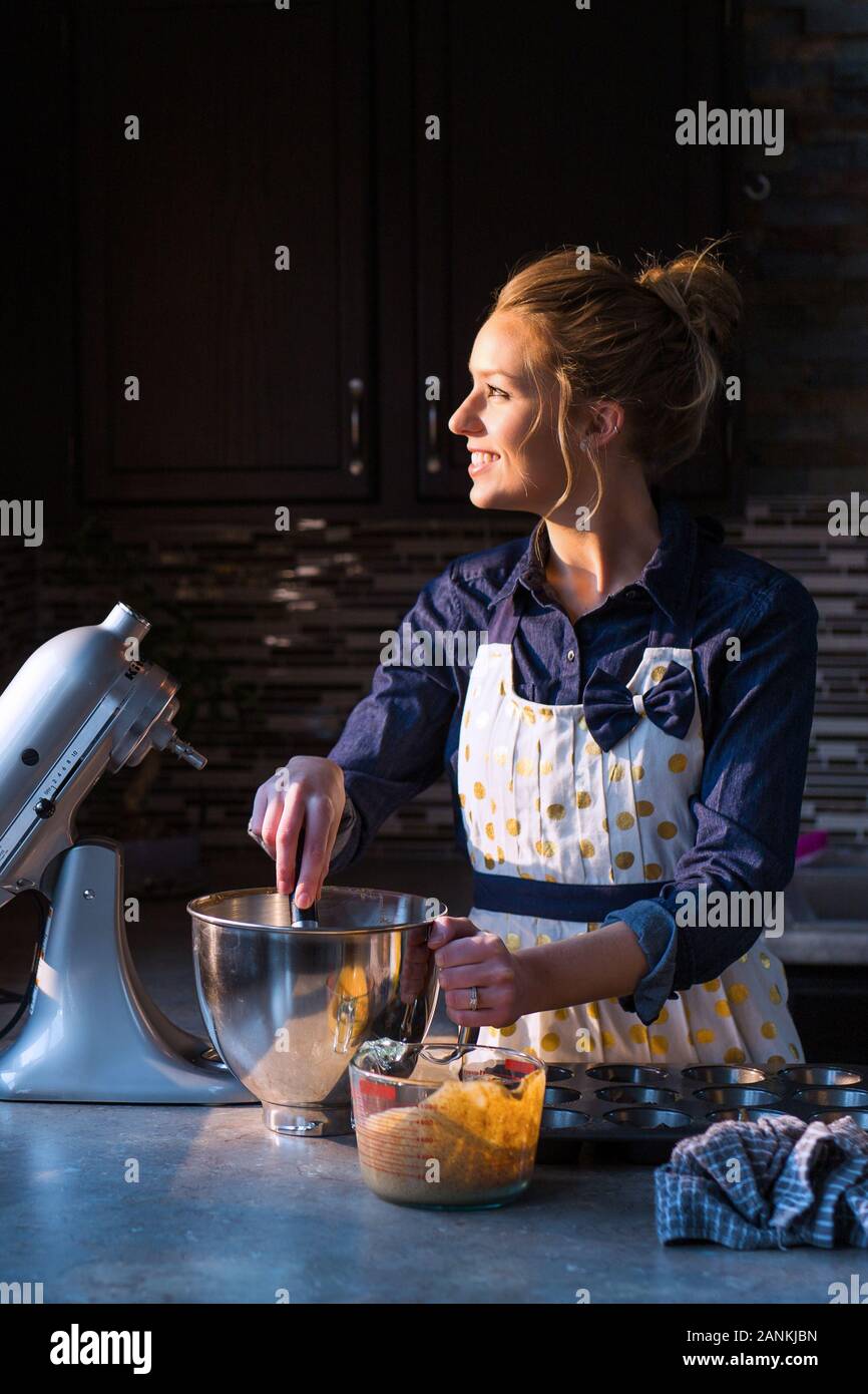 A young woman mixing ingredients in her mixer Stock Photo - Alamy