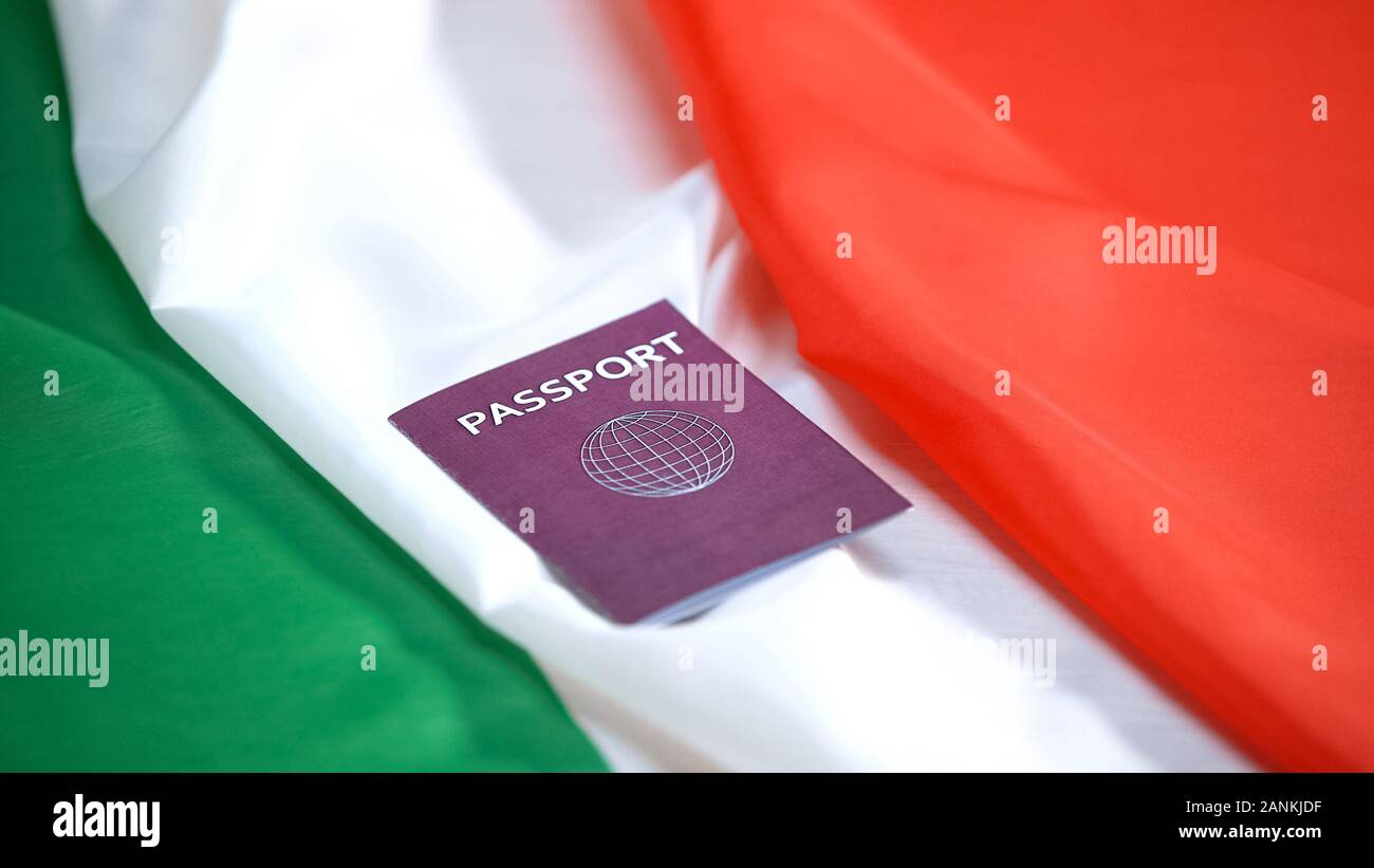 International red passport lying on italian flag, european migration ...