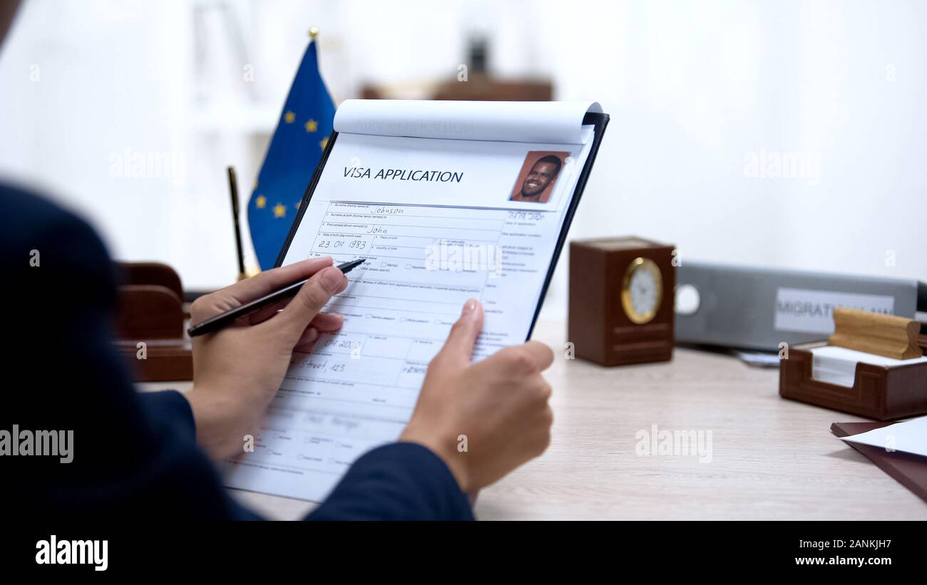 Embassy employee checking visa application office, European Union flag ...
