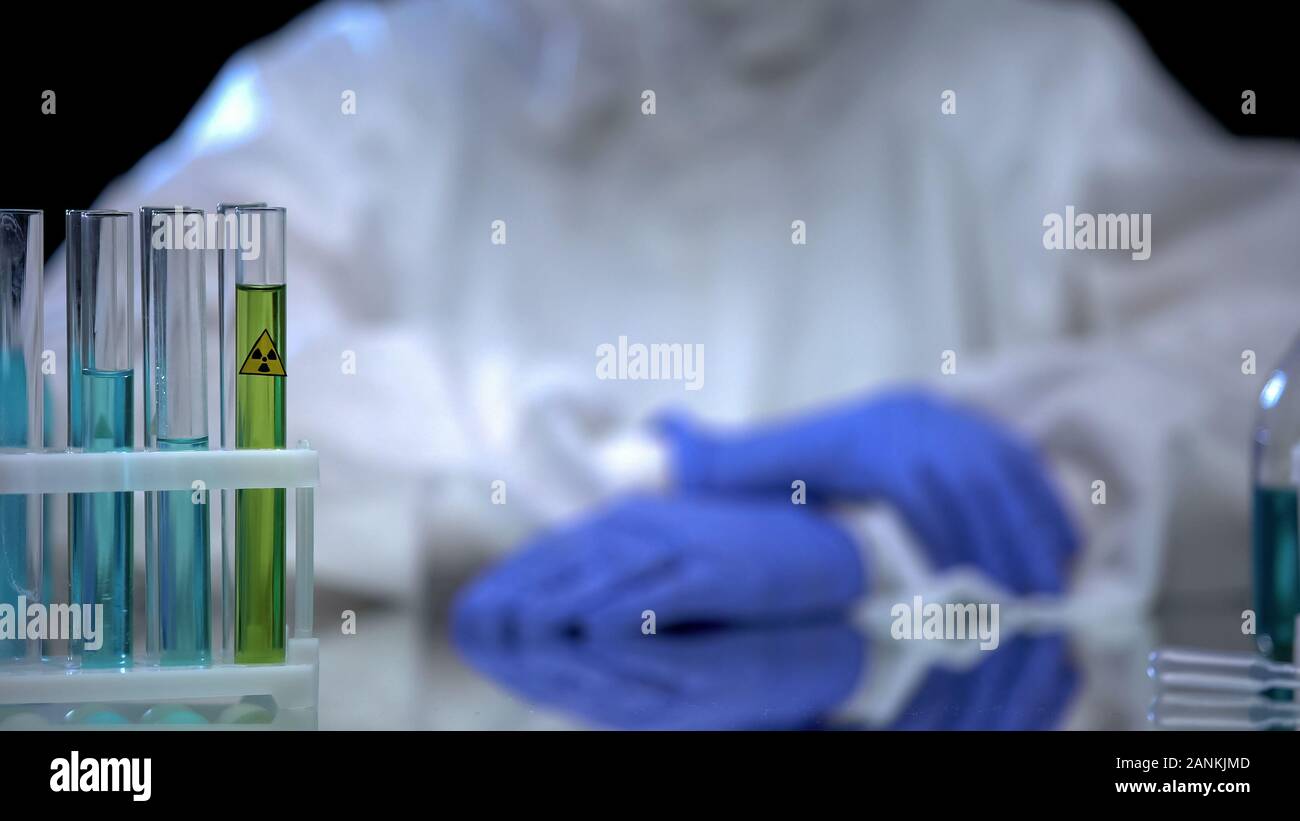 Toxic laboratory analyst working, ionizing radiation liquid standing in ...