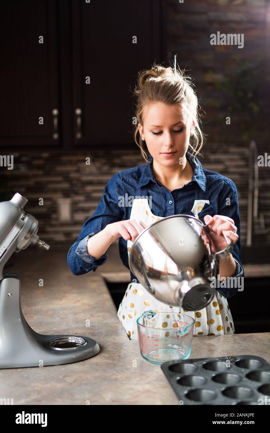 A young woman mixing ingredients in her mixer Stock Photo - Alamy