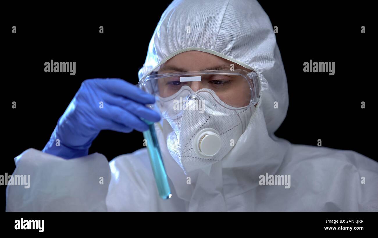 Toxic laboratory worker studying blue fluid in test tube harmful work ...