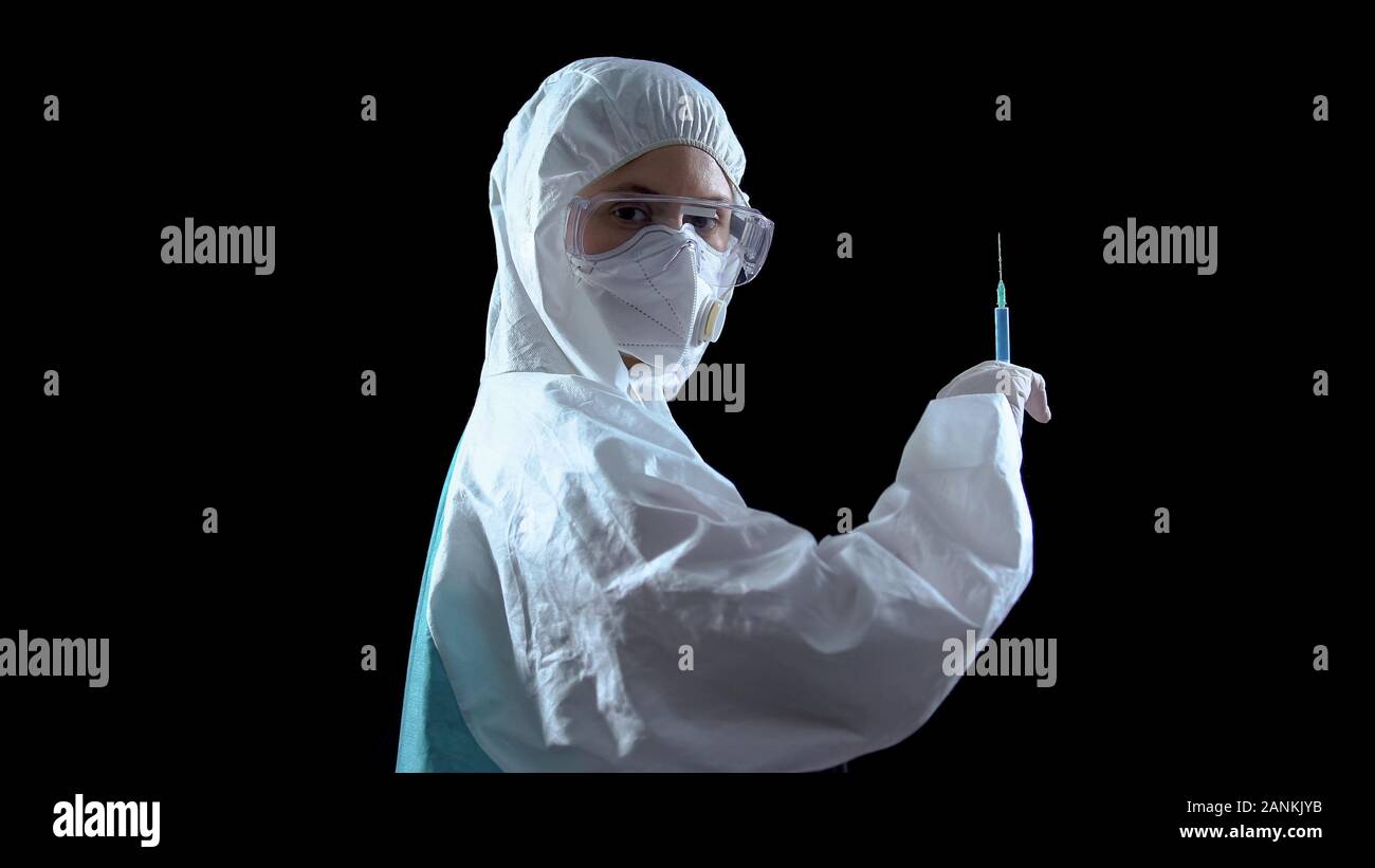 Side view of lab worker with syringe looking at camera, biological ...