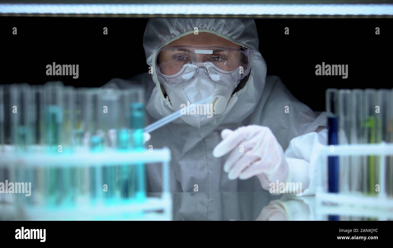 Professional laboratory assistant studying liquid in test tube, medical ...