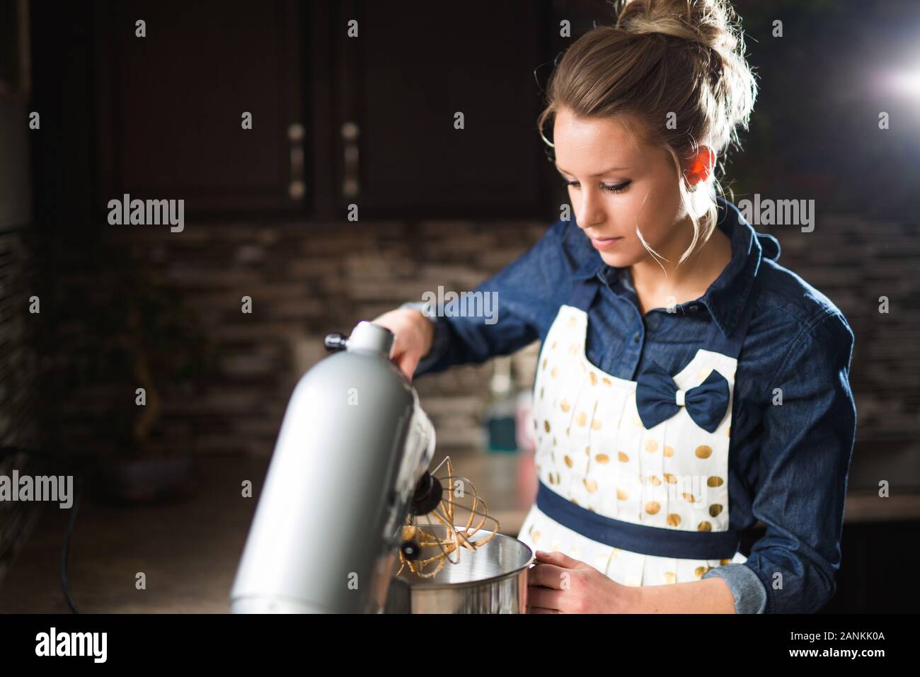 A young woman mixing ingredients in her mixer Stock Photo - Alamy