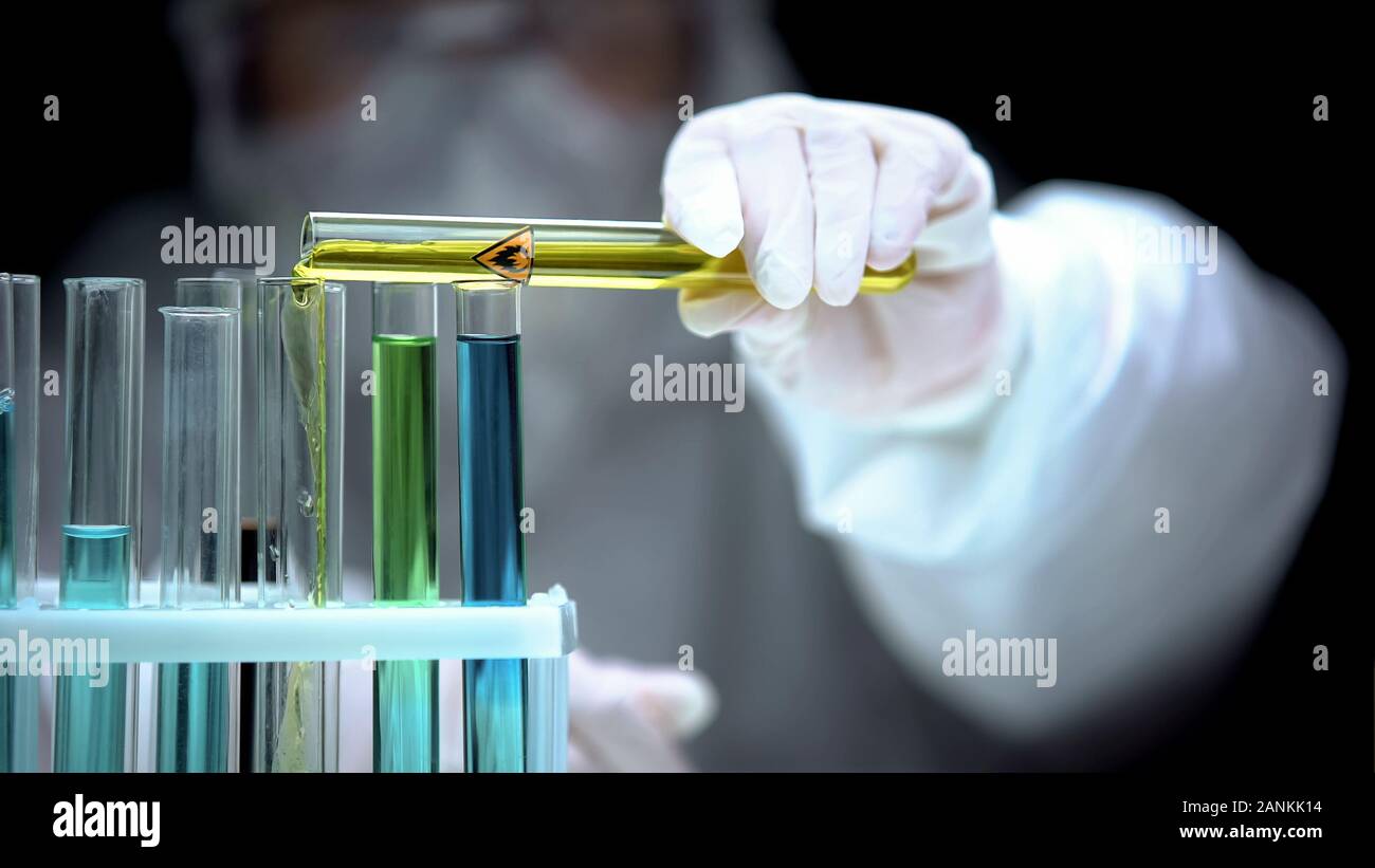 Researcher adding liquid from test hi-res stock photography and images ...