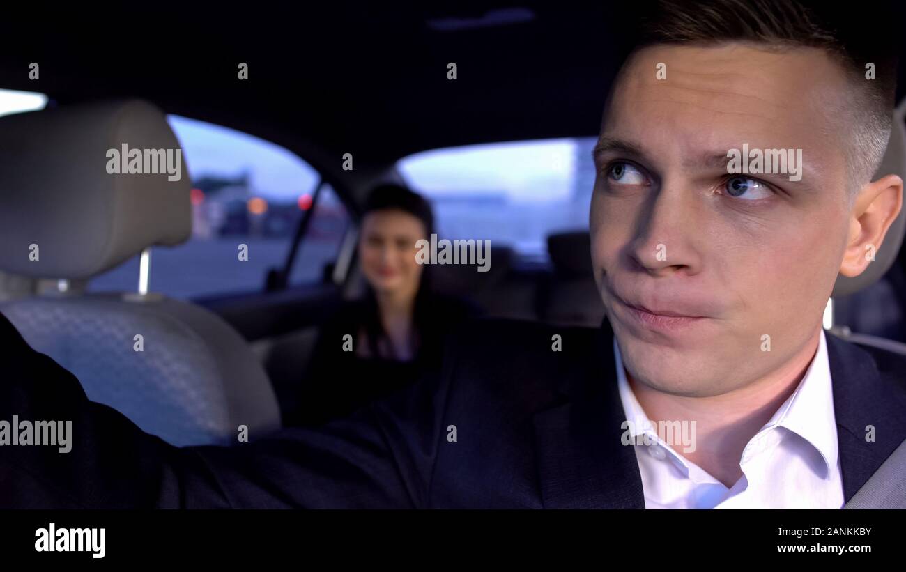 Driver looking dissatisfied and irritated about client in car, bad taxi ...
