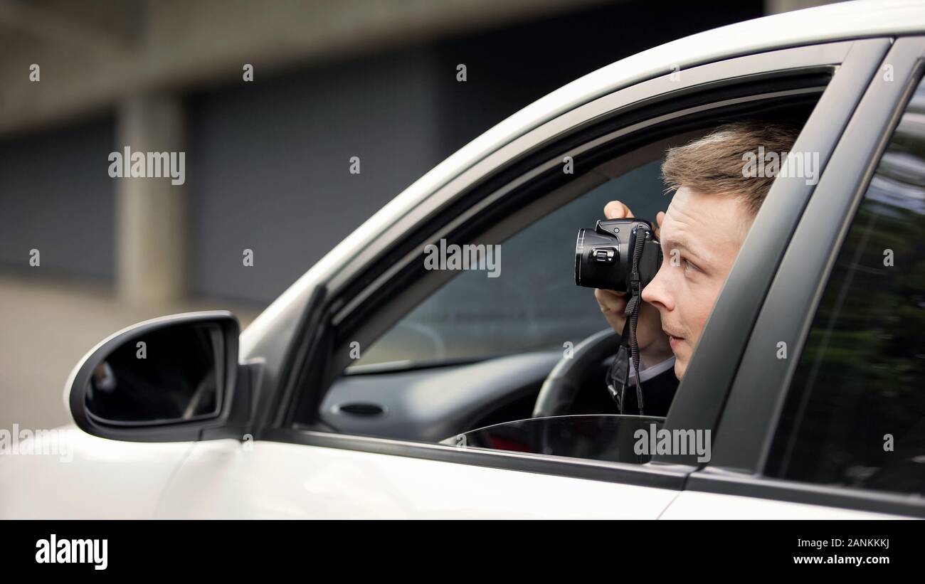 Reporter secretly taking photo sitting in auto, spying paparazzi ...