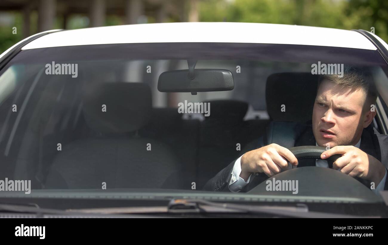 Shocked male driver sitting car, road negligence, human factor ...