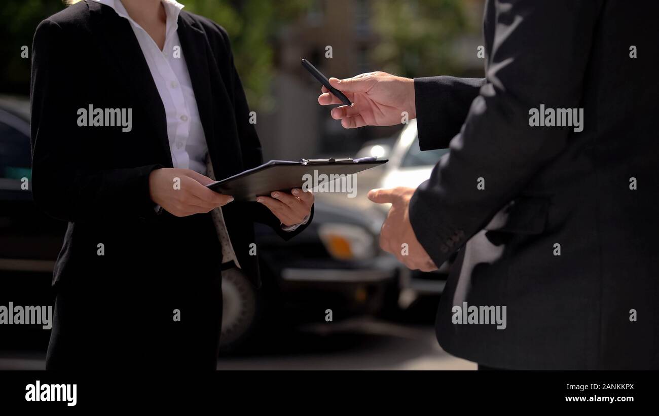 Male agent giving pen to female business partner, signing contract ...