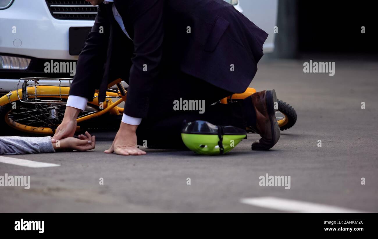 Boy helping accident hi-res stock photography and images - Alamy