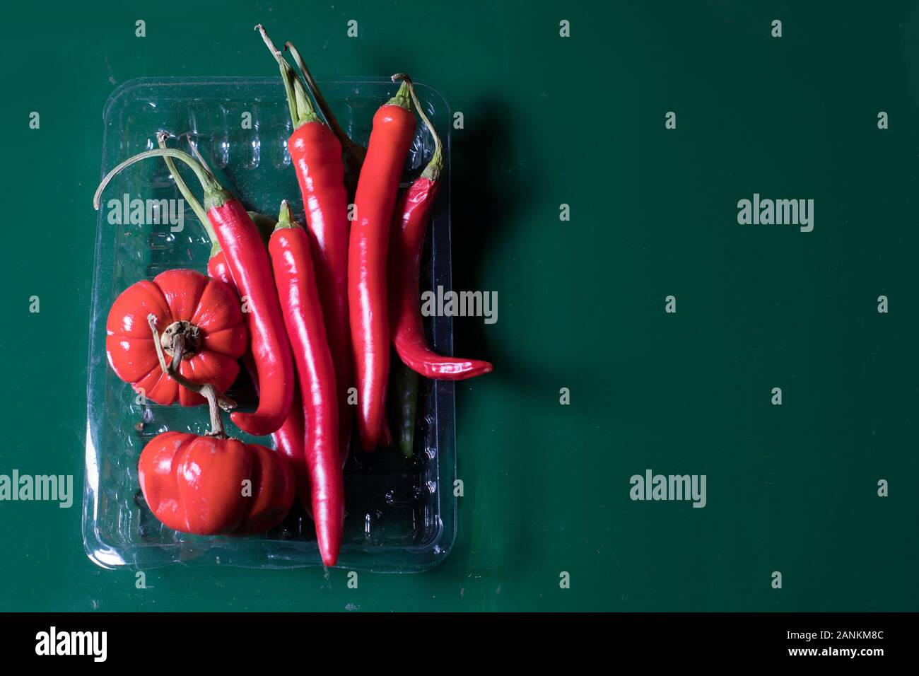 red peppers of various shapes on green background Stock Photo - Alamy