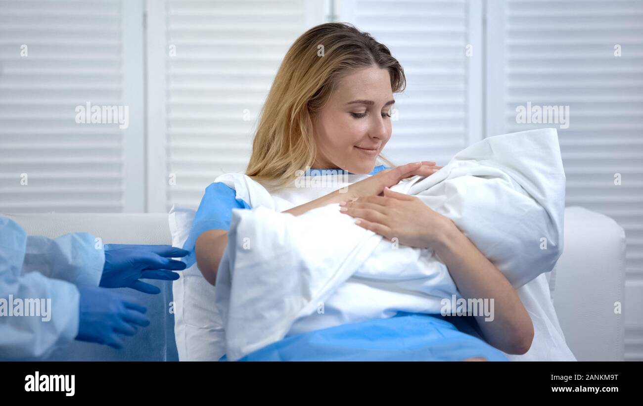 Mother holding newborn child after labor and delivery, magnificent ...