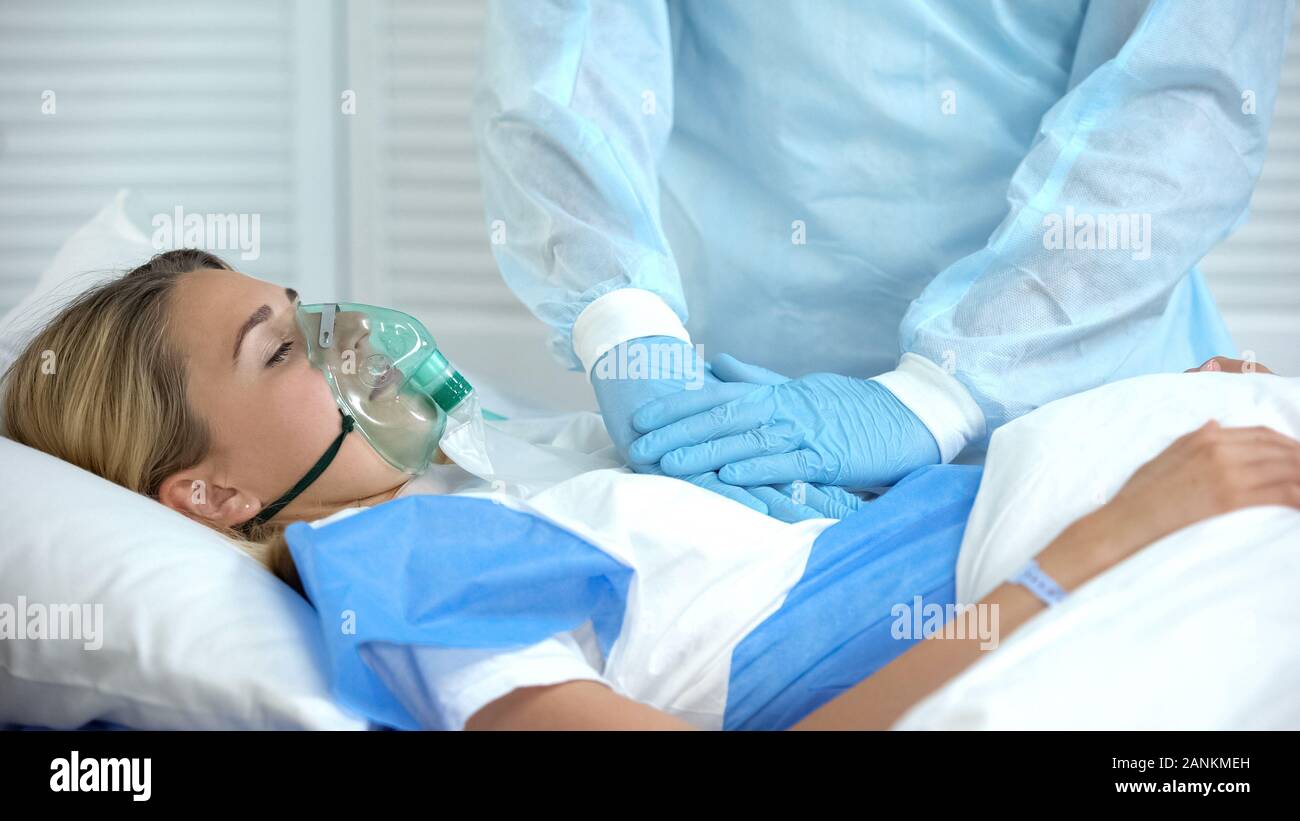 Doctor making cardiopulmonary resuscitation to female patient ...