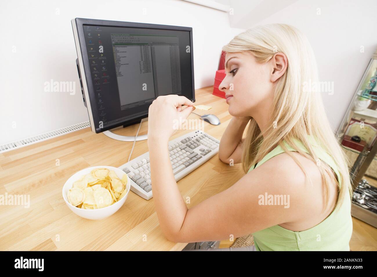 Woman eating chips computer hi-res stock photography and images - Alamy