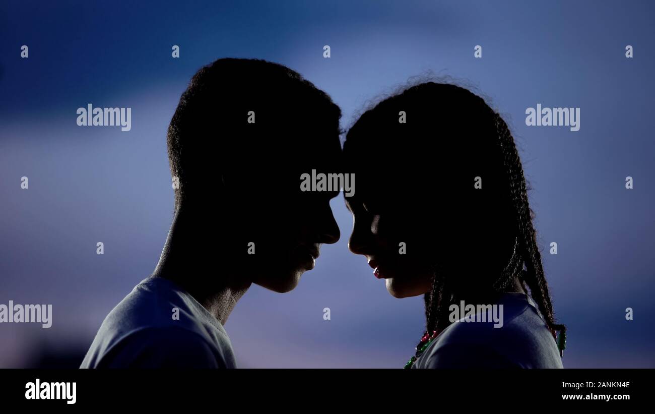 African couple putting foreheads together, promising love forever ...
