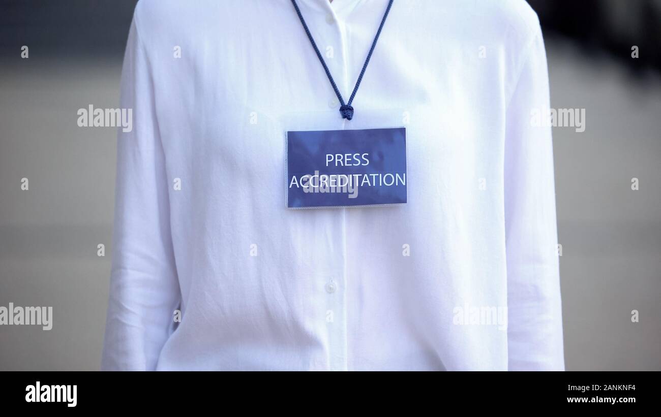 Close-up of female with press accreditation badge, journalist event ...