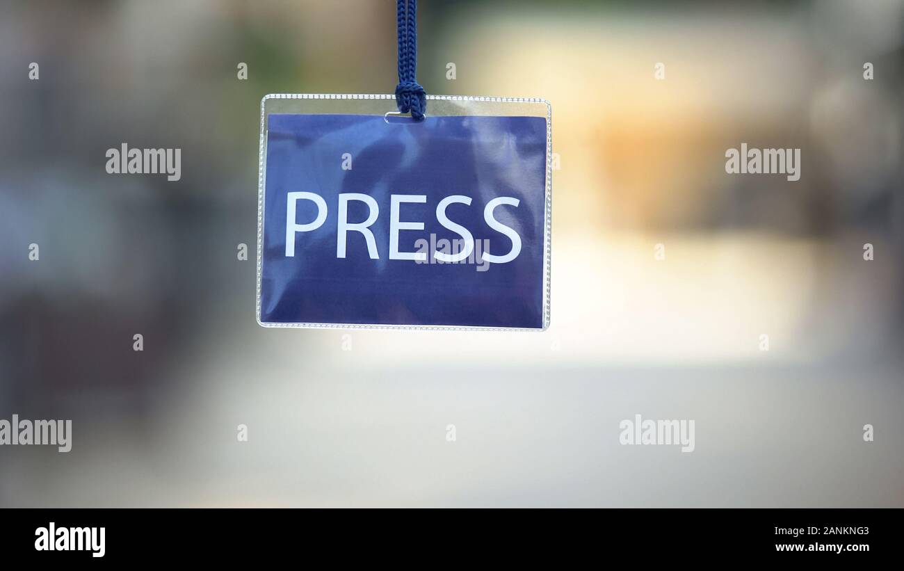 Press identification card against blurred background, privilege pass ...