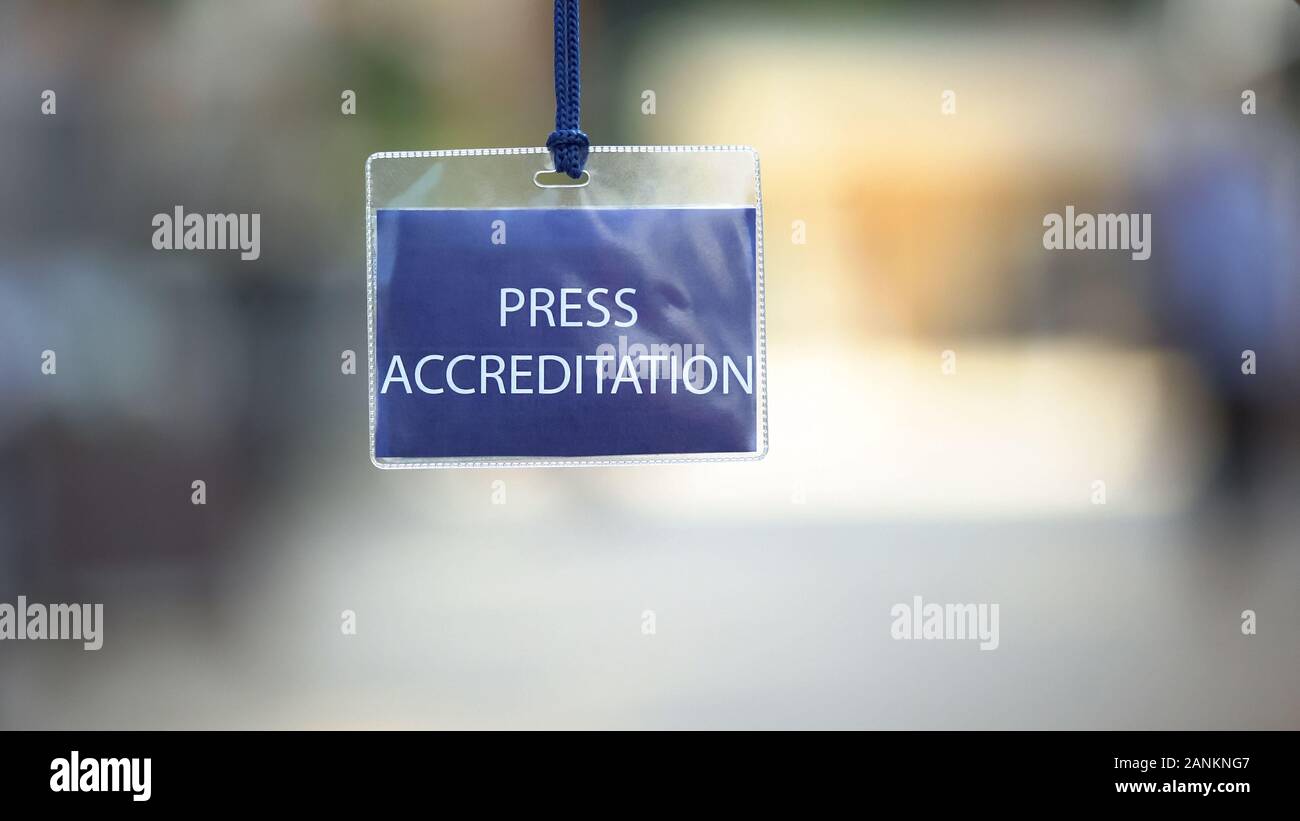 Press accreditation pass against blurred background, media ID card ...