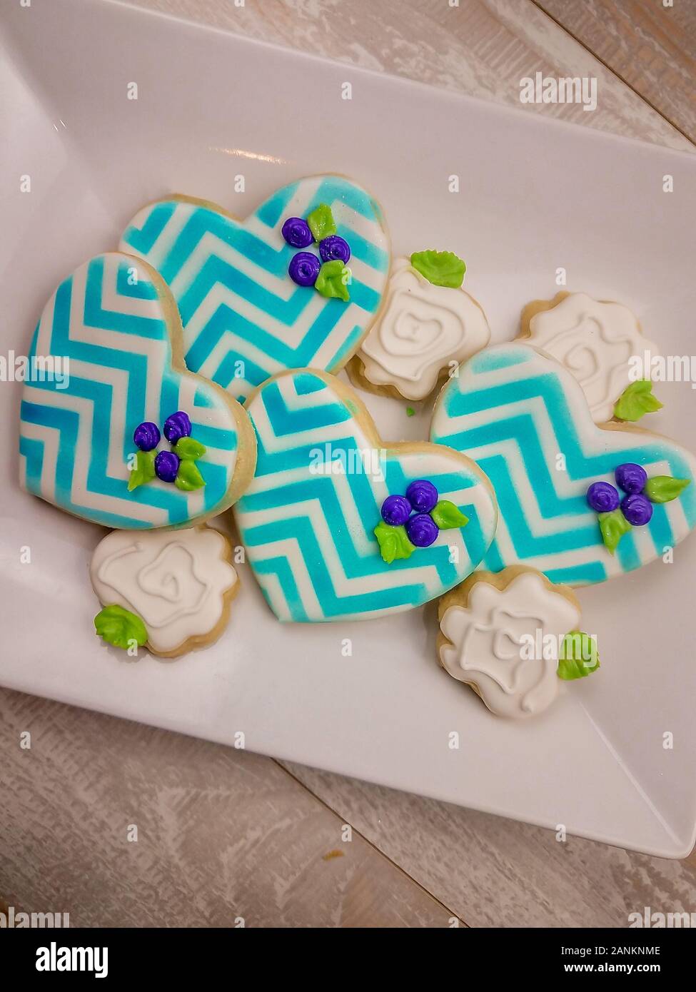 Contemporary blue stripted heart sugar cookies decorated with flowers ...