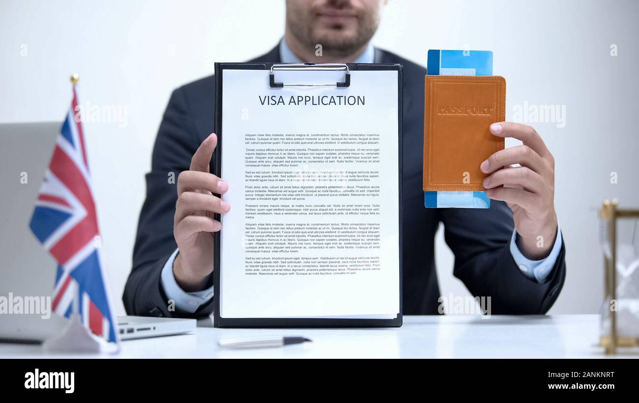 British consular officer holds visa application and passport, tourist ...