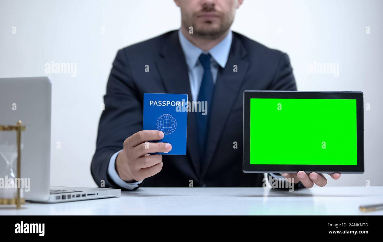 Migration agent holding passport and tablet, tourist visa application ...