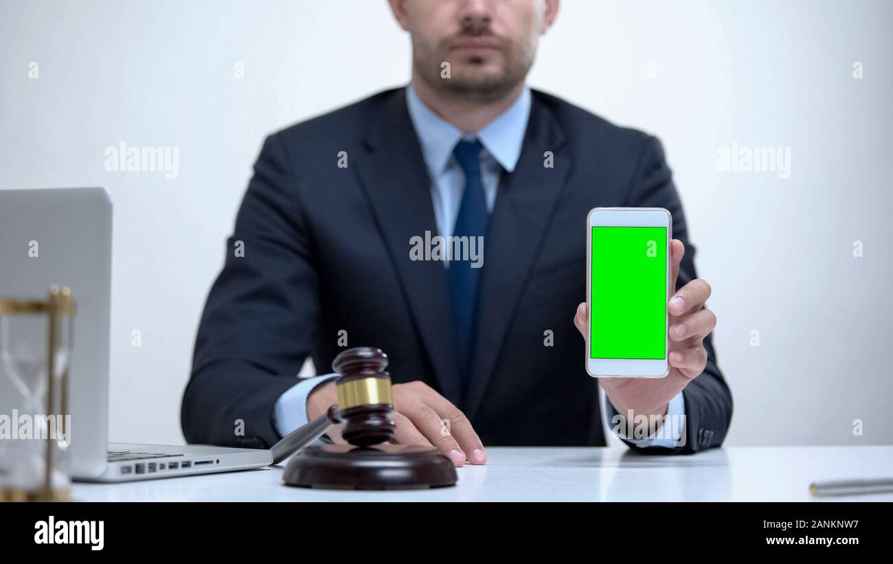 Confident attorney holding green screen cellphone, constitutional law mobile app Stock Photo - Alamy