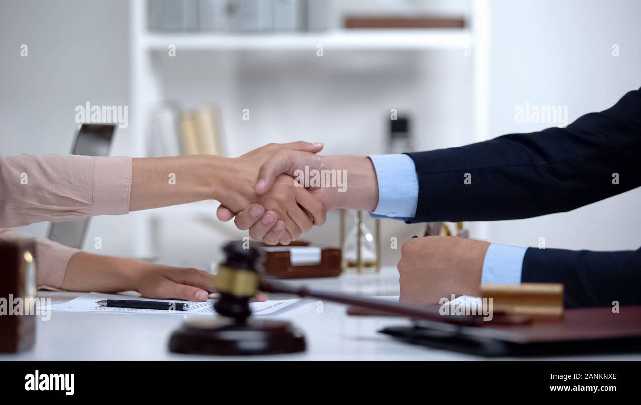 Woman shaking hands with lawyer, successful deal, advertise of attorney ...