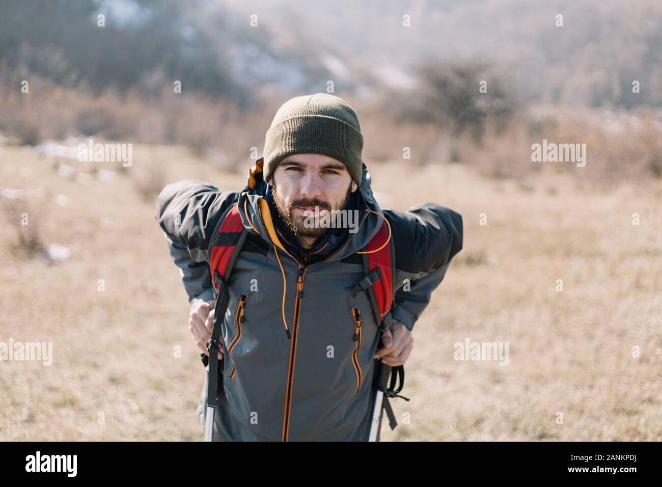 Bearded hiker man walking on hills path using poles Stock Photo - Alamy