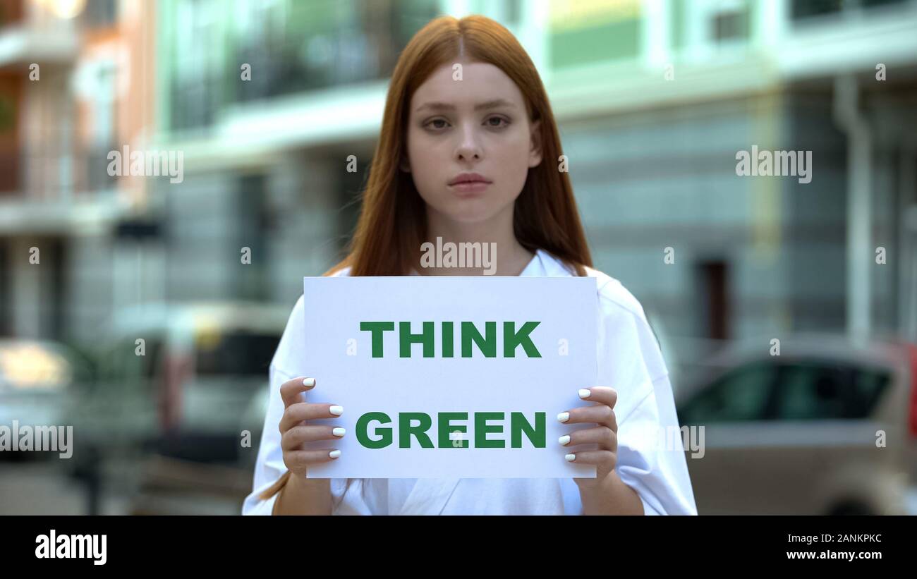 Think green sign in hands of girl, teenagers campaign against ...