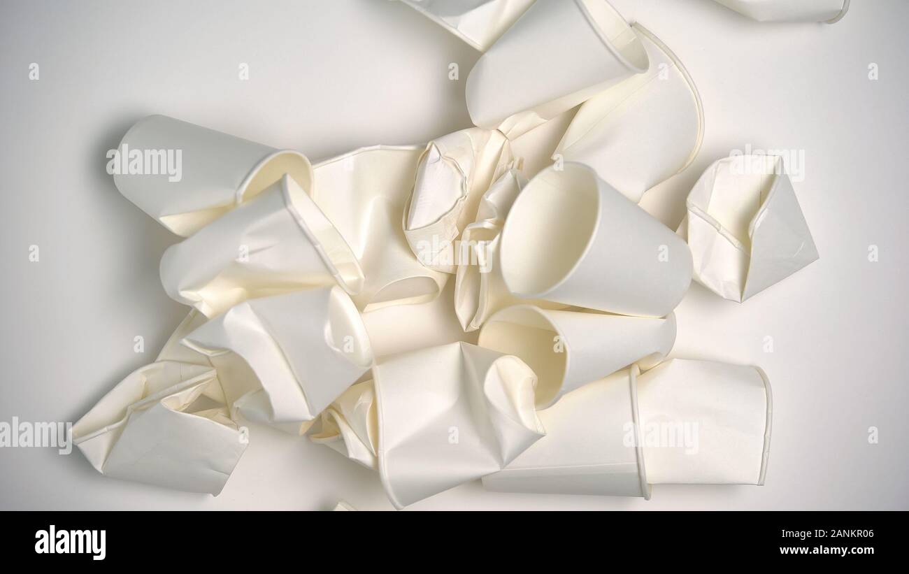 Used paper cups lying on light background, waste sorting problem ...