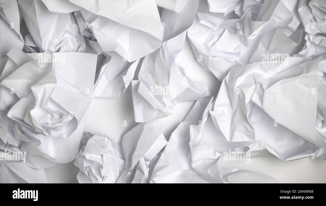 Crumpled paper sheets in office, inefficient material usage, ecological ...