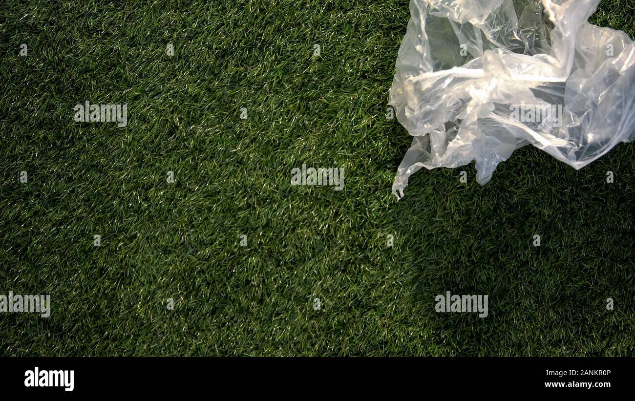 Plastic packing lying on grass, dangerous responsibility towards earth ...