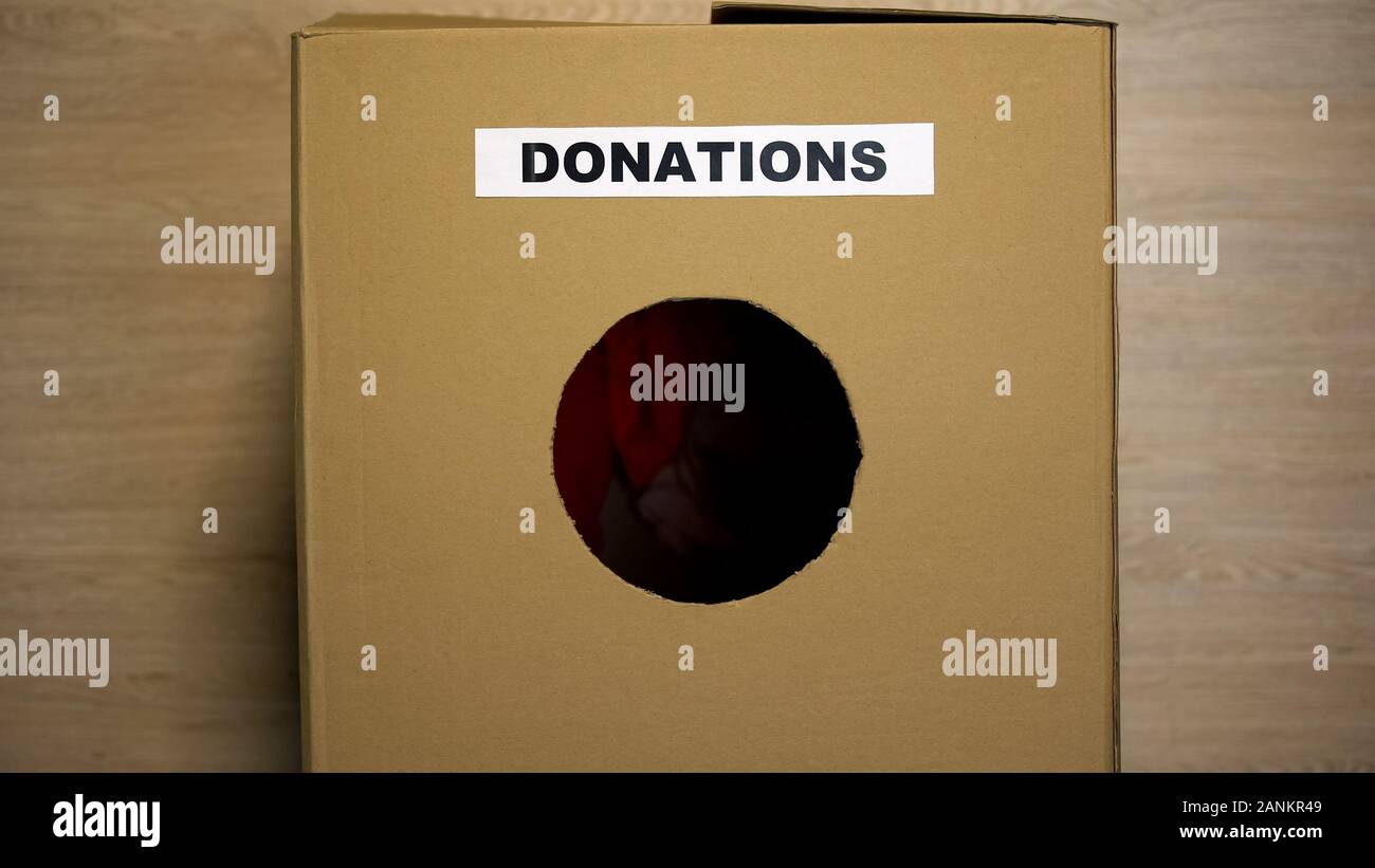 Donations cardboard box with clothes, volunteering organization ...