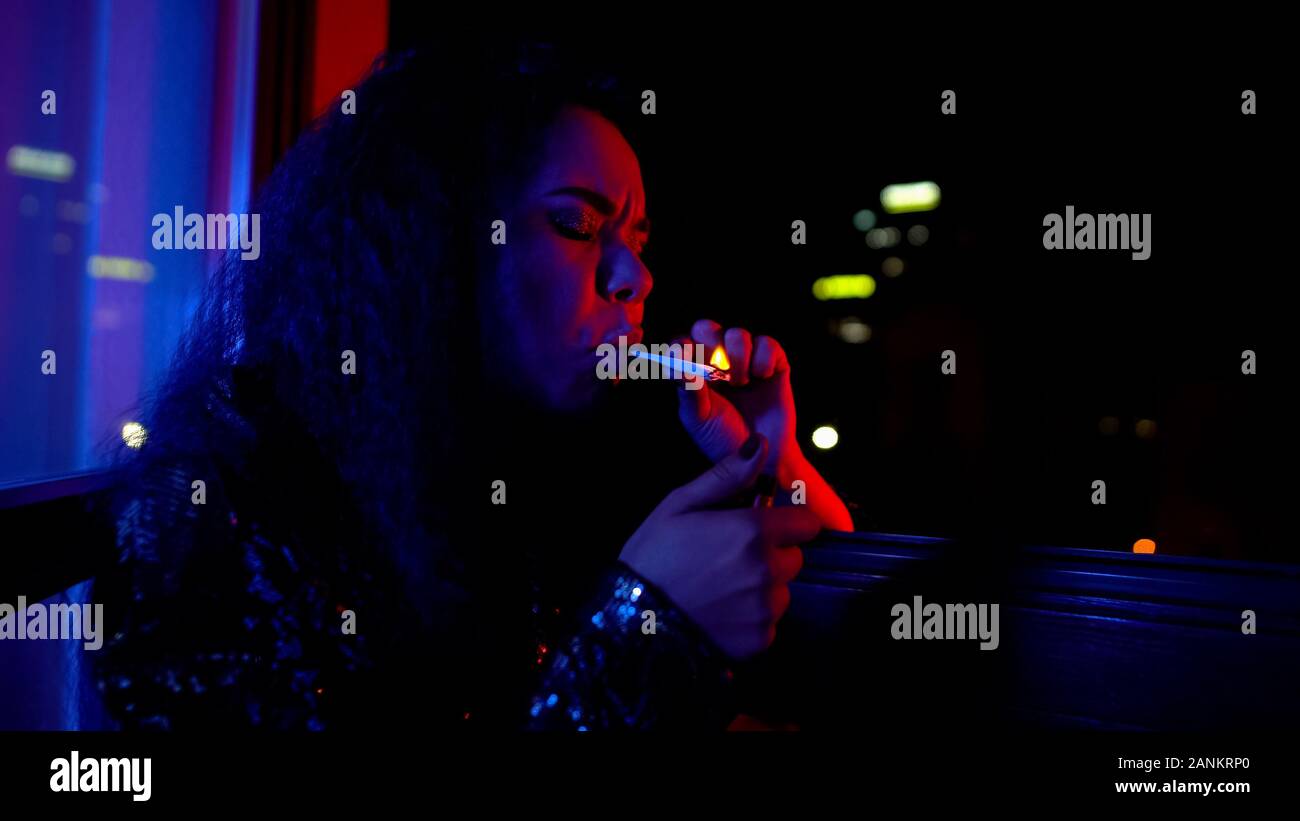 High woman smoking weed joint at night private party, drug addiction ...