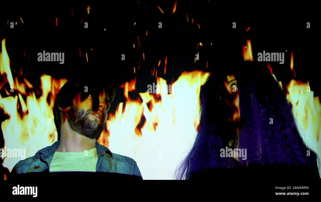 Couple dying in fire flames, looking at each other with love, arson ...