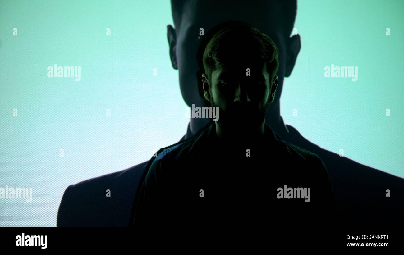 Sad male standing against silhouette of successful businessman, lost ...